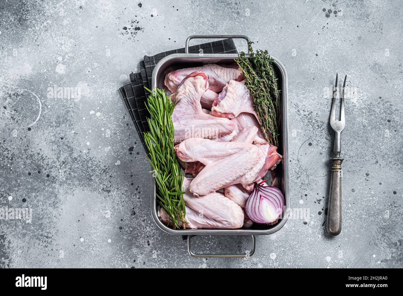 Raw duck wings in a steel tray. Gray background. Top view Stock Photo ...