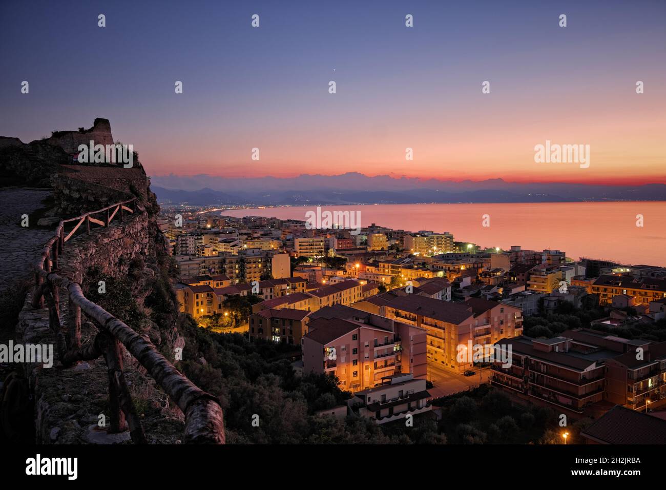 night landscape of sea and coast in Sicily the city of Milazzo at the ...