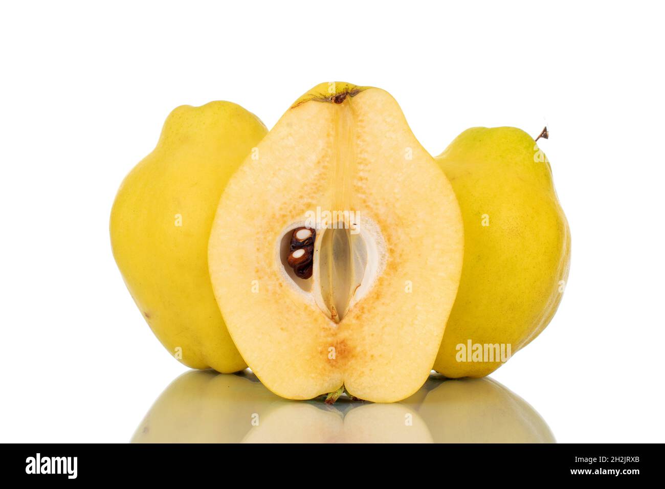 One half and two whole ripe organic quince, close-up isolated on white ...