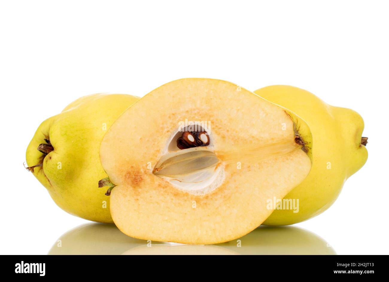 One half and two whole ripe organic quince, close-up isolated on white ...