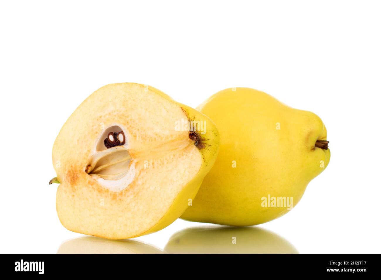 One half and one whole ripe organic quince, close-up, isolated on white ...