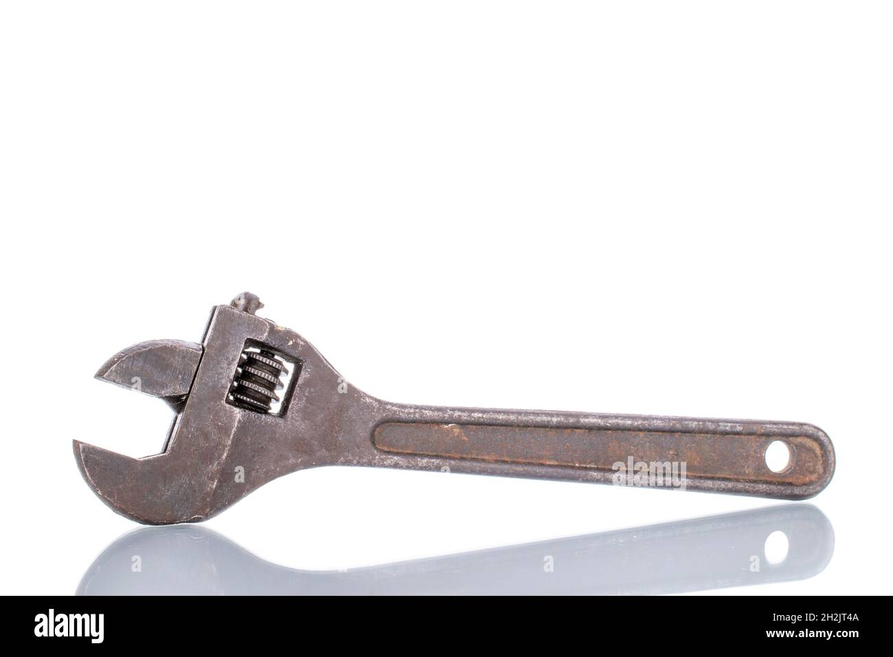 One old metal adjustable wrench, close-up, isolated on white Stock ...