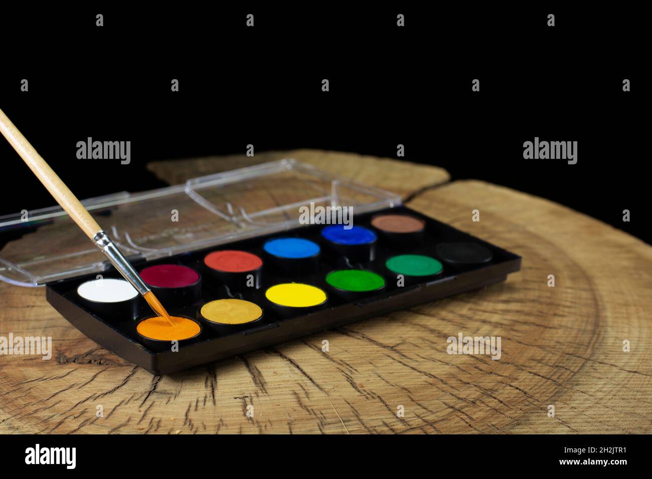 colorful watercolor set for painting on wooden table Stock Photo - Alamy