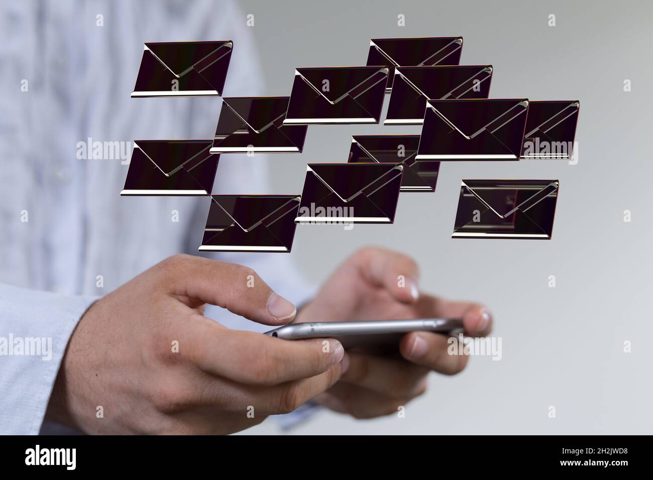 Male sending emails with floating email icons on his phone Stock Photo ...