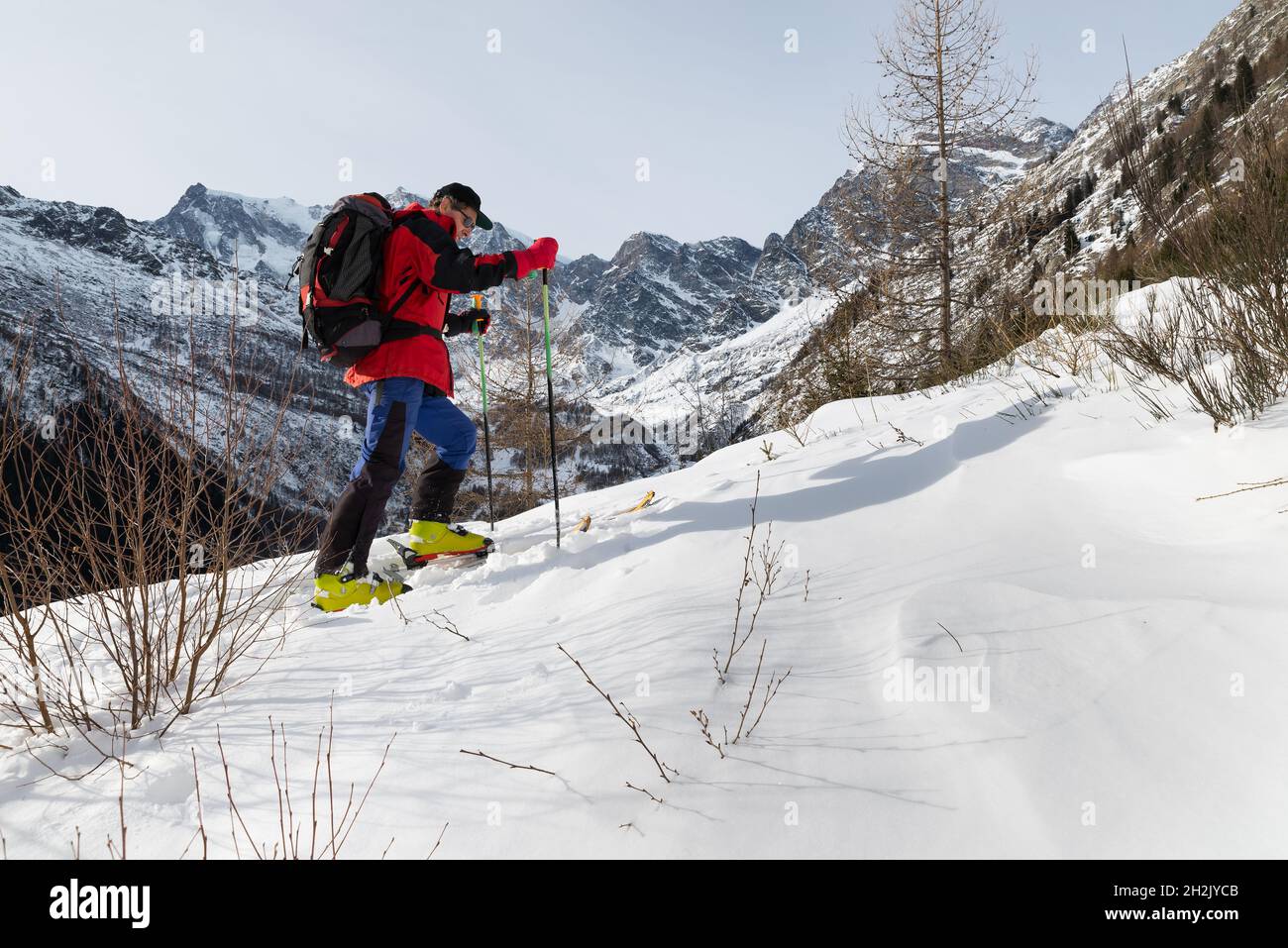 Ski mountaineer on the Italian Alps with the backdrop of the east wall ...