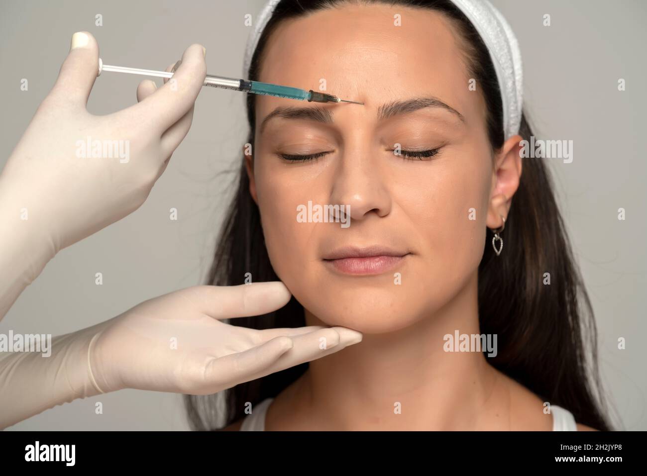 Portrait of a young satisfied woman on a face filler injection ...