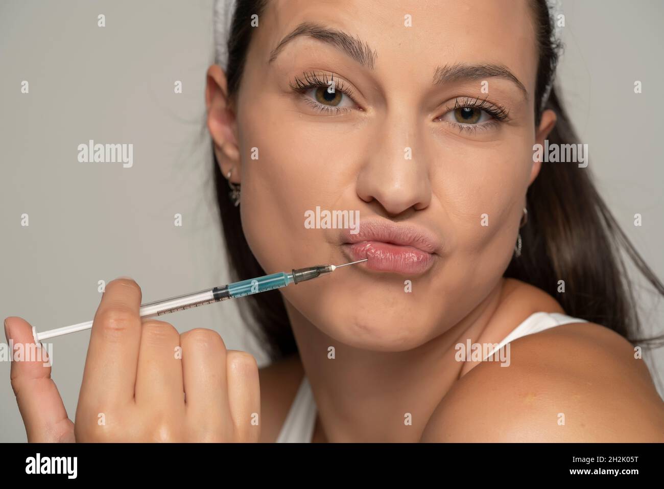 Portrait of a young beautiful woman on a lip filler self injection ...