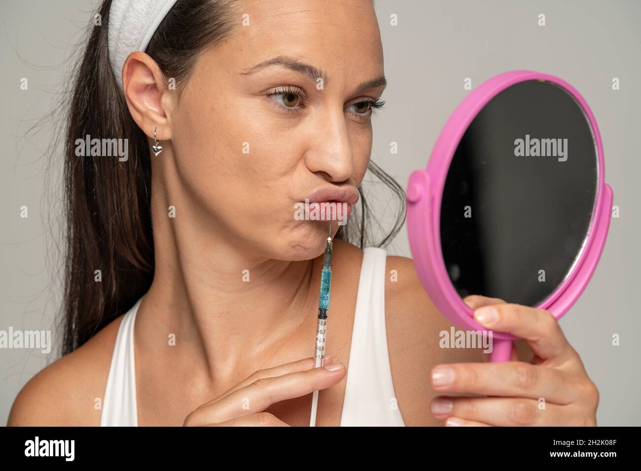 Portrait of a young beautiful woman on a lip filler self injection ...
