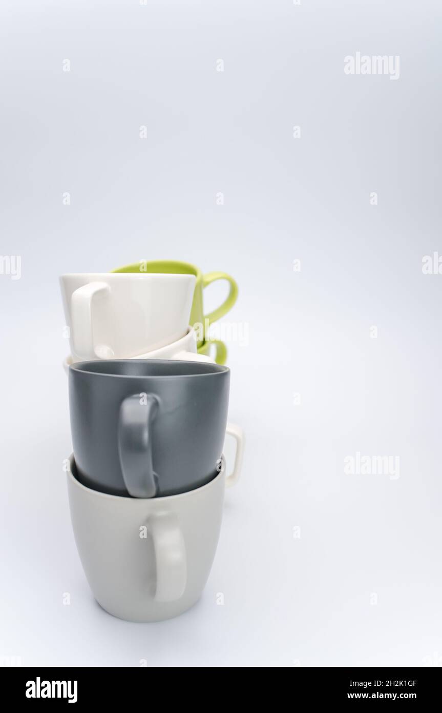 set of piled up mugs on a white background with space for text Stock ...