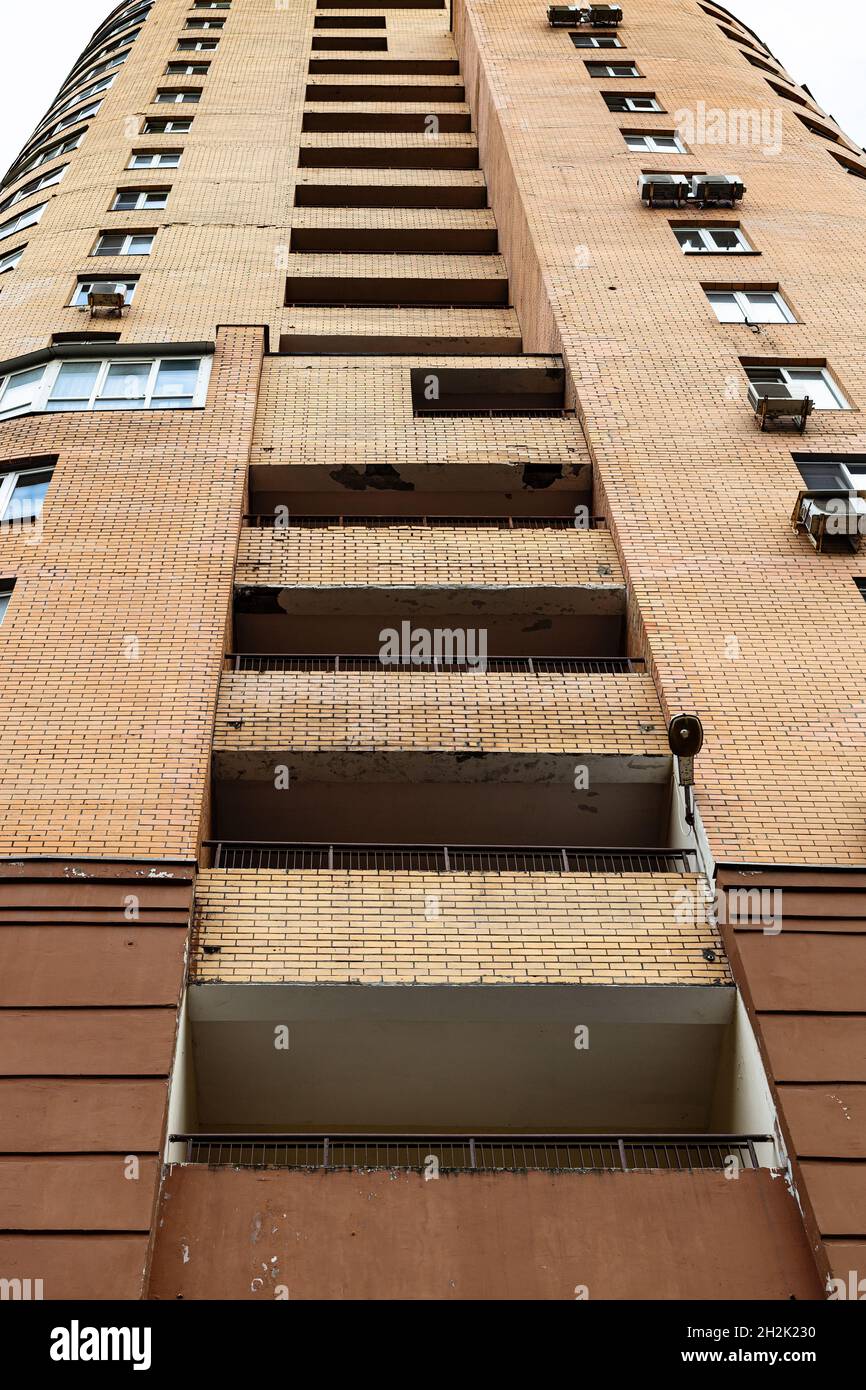 bottom view of facade of high-rise brick house in summer evening Stock ...