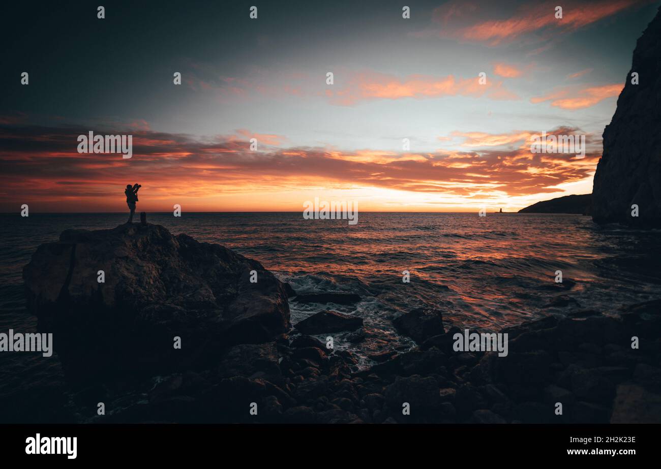 Man photographing the sunset in Spain Stock Photo - Alamy