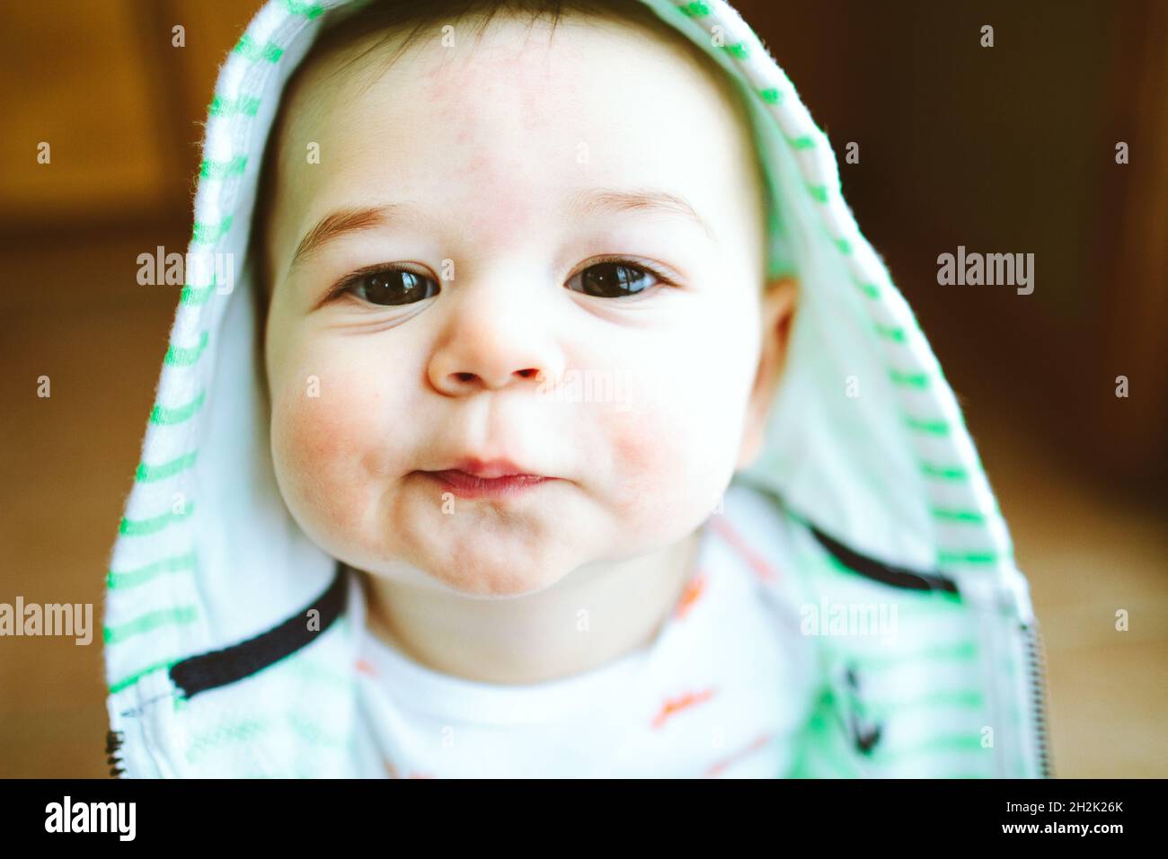 A baby boy looking directly into the camera Stock Photo - Alamy