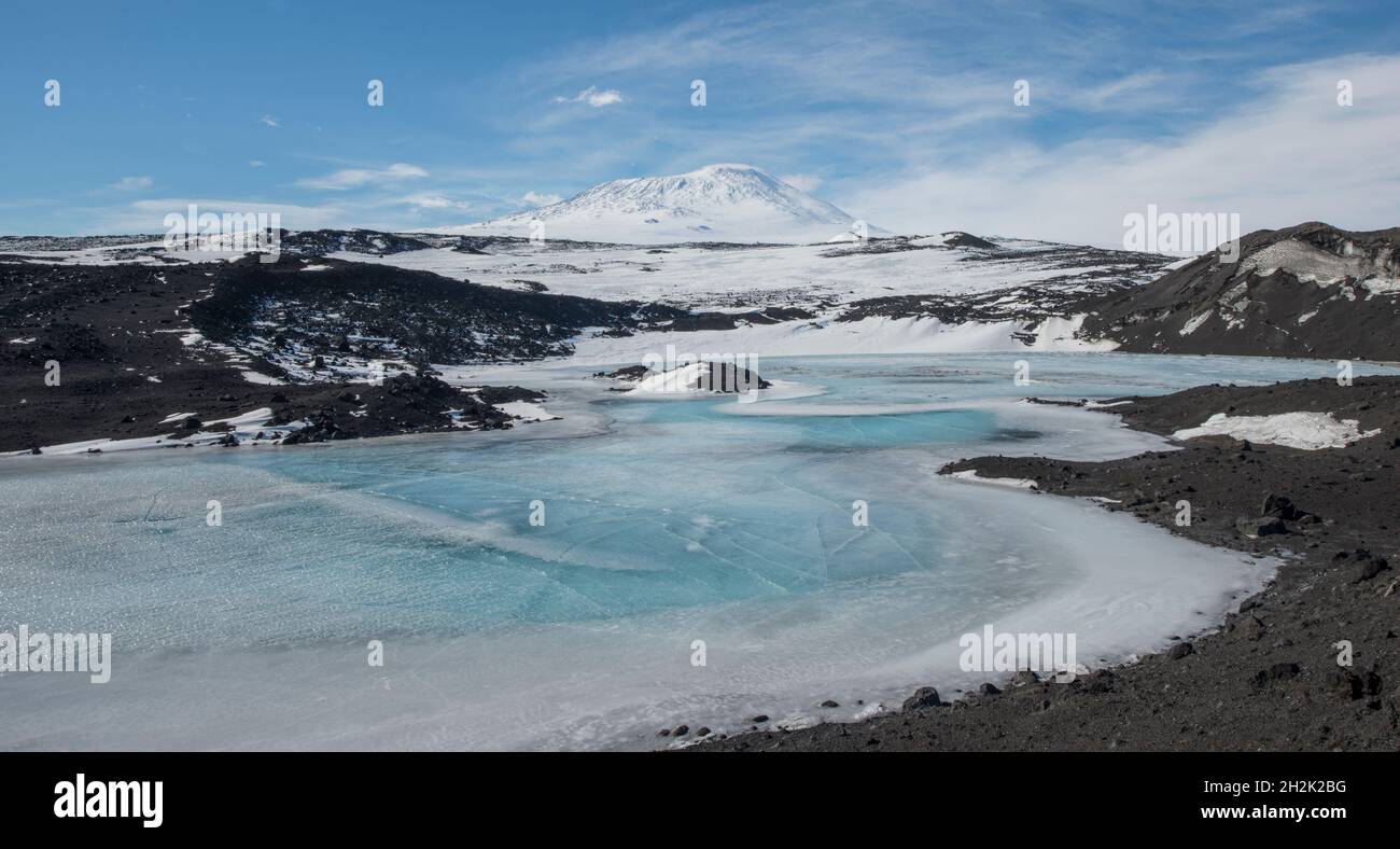 A frozen lake at Cape Royds, Antarctica with Mount Erebus behind Stock ...