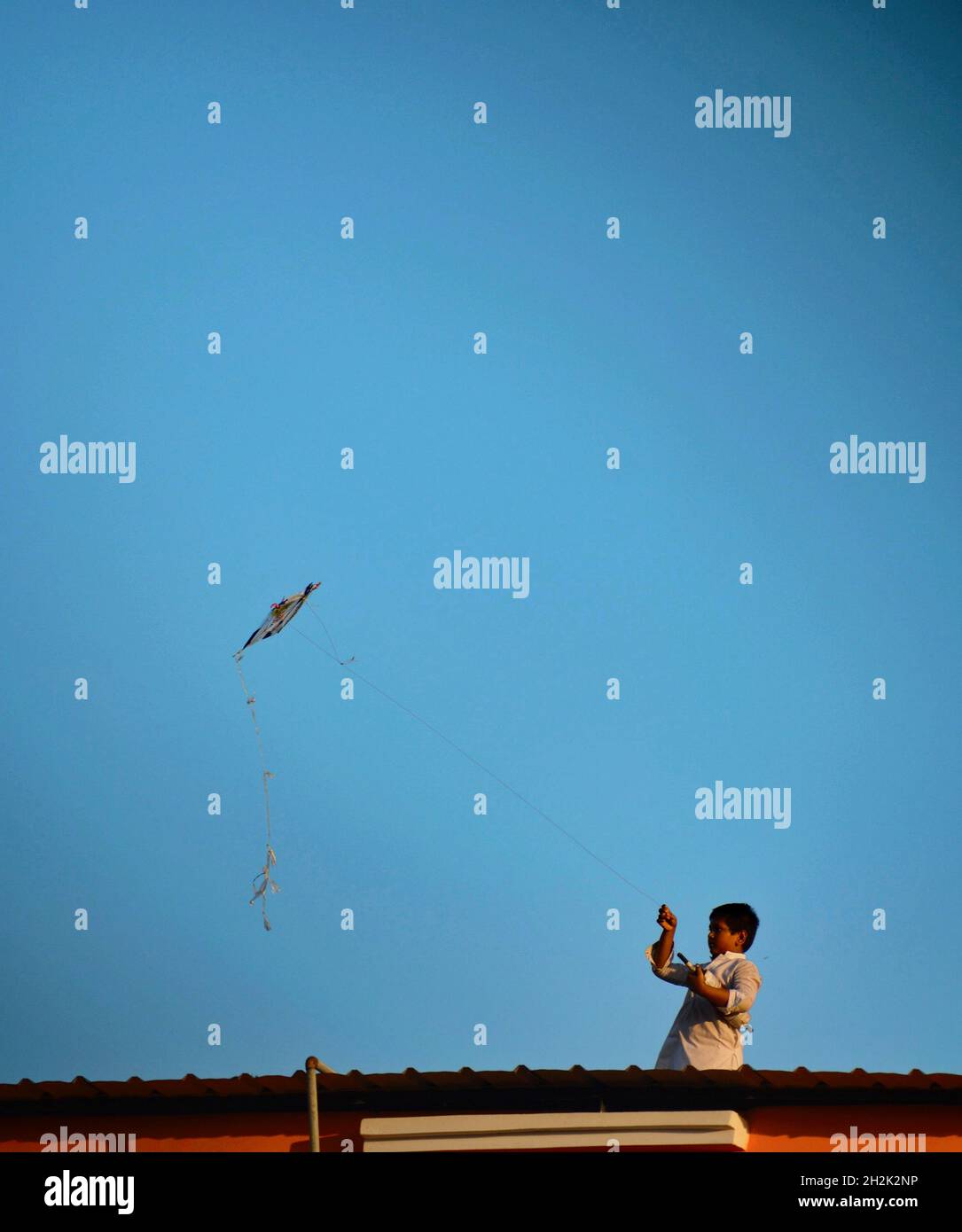 A boy is flying kite Stock Photo - Alamy