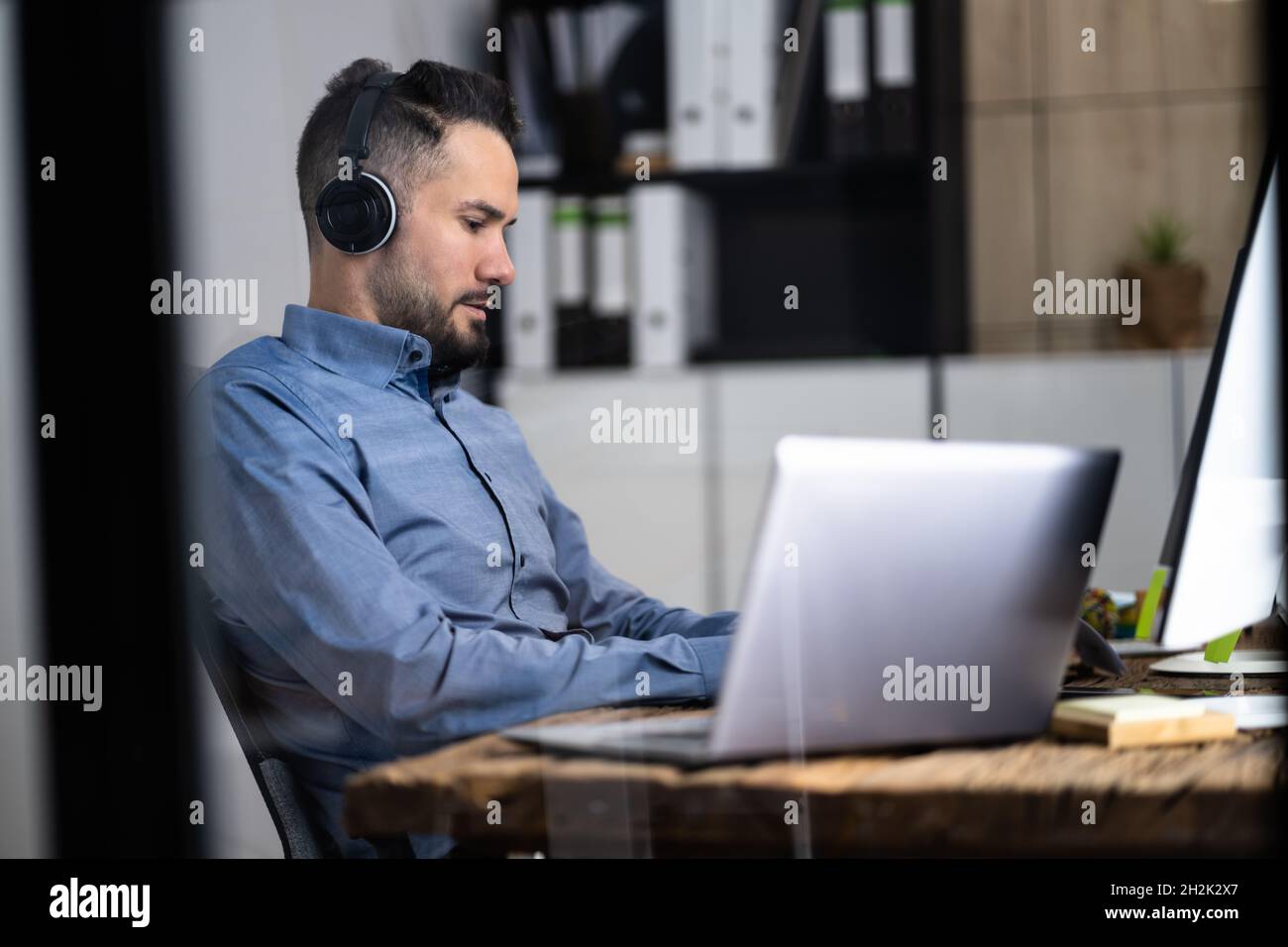 Employee Working On Desktop Computer In Home Office Stock Photo - Alamy