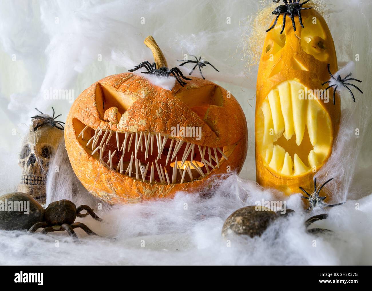 Halloween theme, carved pumpkin with a scary smile, spiders, skull ...