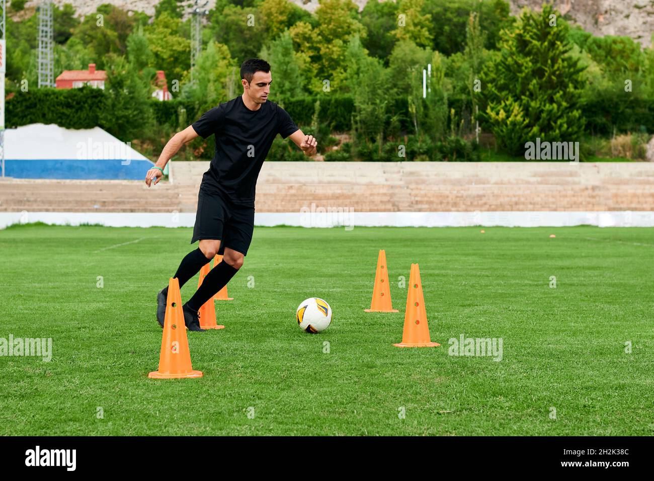 A football player training on a soccer field Stock Photo - Alamy