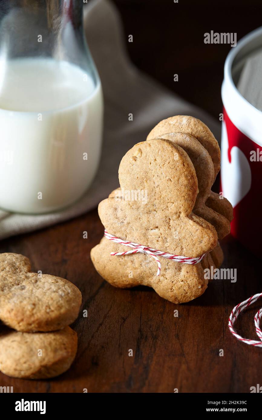 tied up stack of almond gingerbread men with milk Stock Photo - Alamy