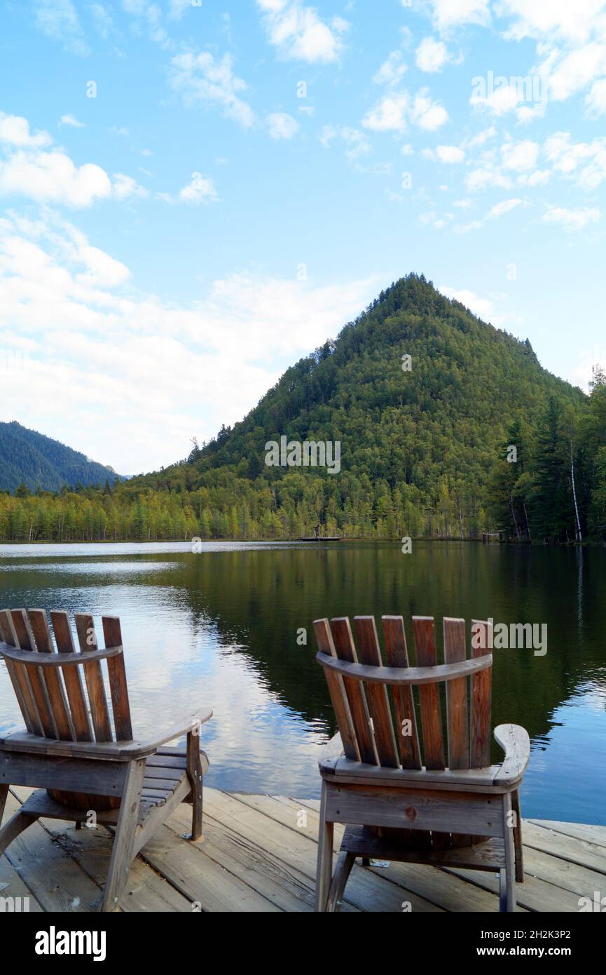 Two wooden deck chairs for relaxing on Warm lakes Stock Photo - Alamy