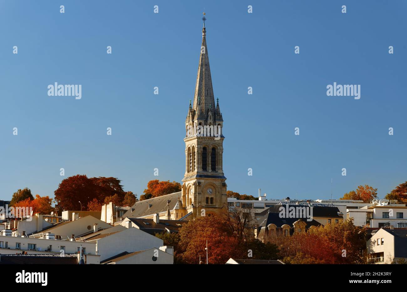 The Saint Clodoald church and autumn trees. It was built in 1815-1892 ...