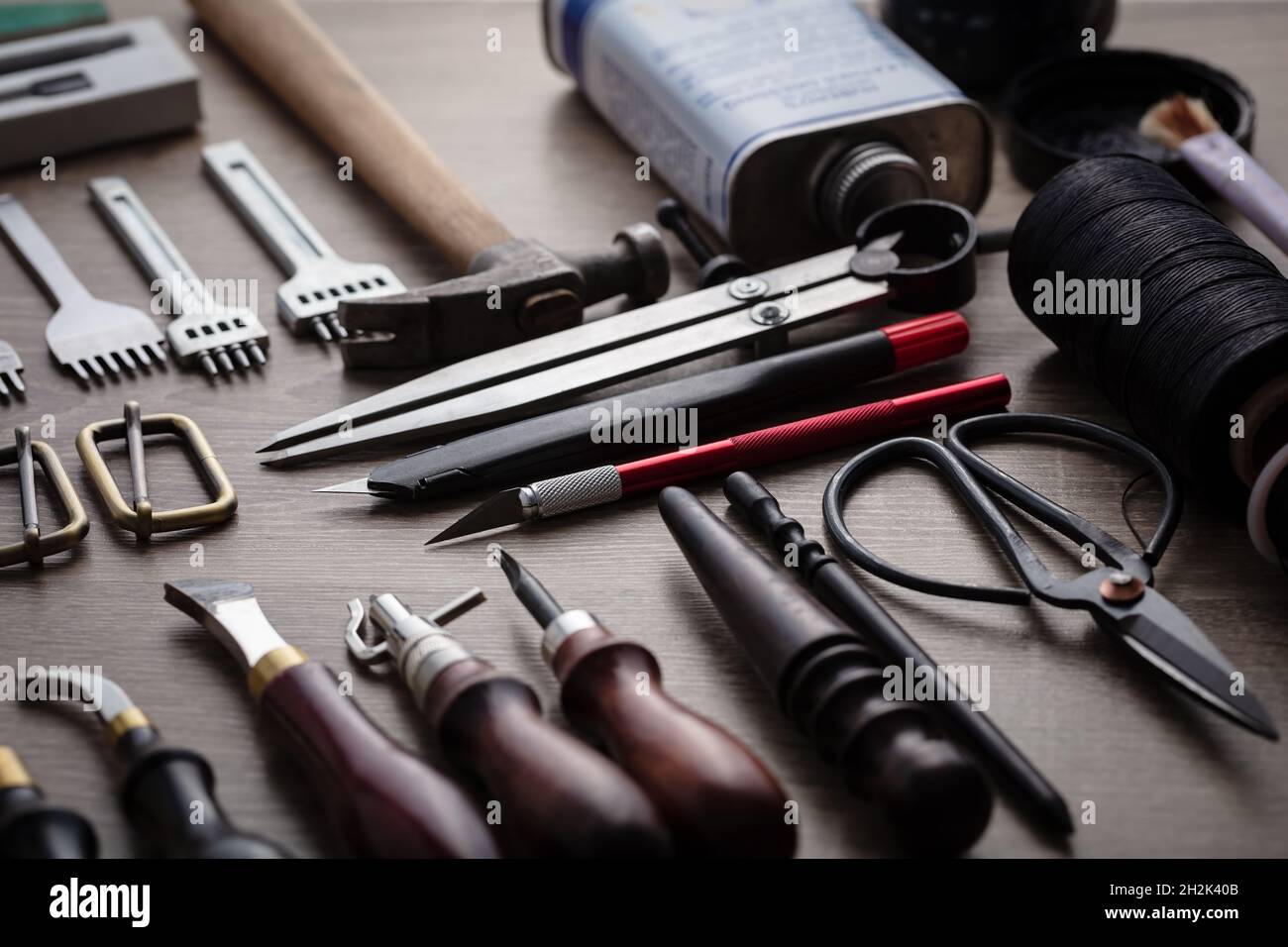 Concept of leather handcraft instruments. Instruments laying on a table ...