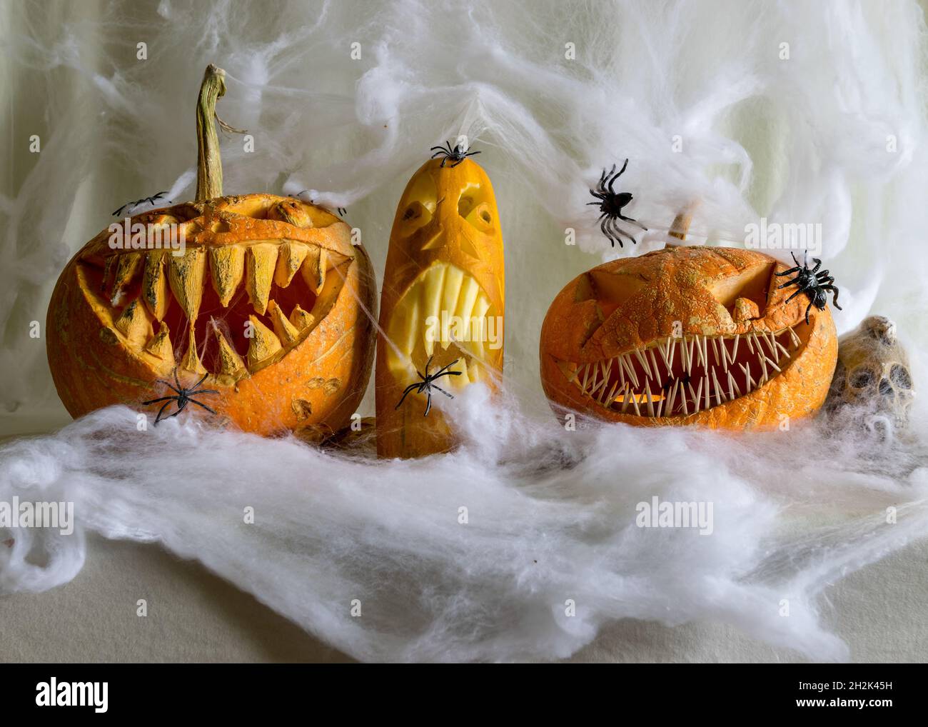 Halloween theme, carved pumpkin with a scary smile, spiders, skull ...