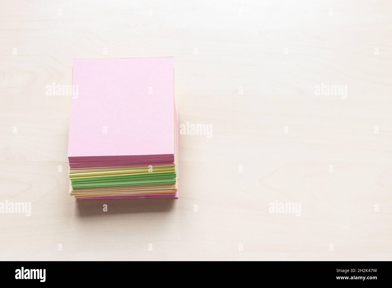 top view of stacks of blank colorful sheets of note paper on light ...