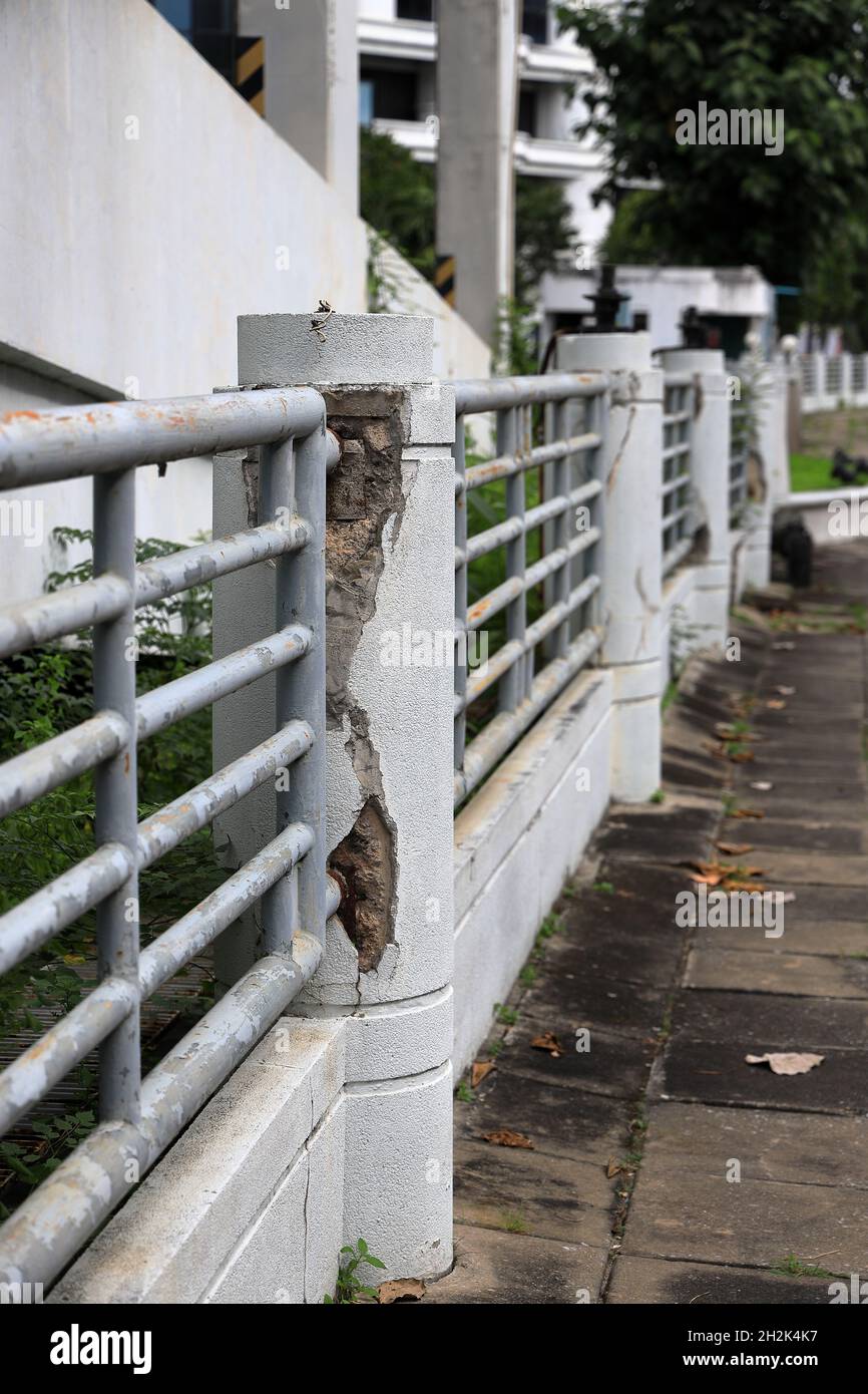 Cracked grey concrete surface with visible reinforcement, Rust in ...