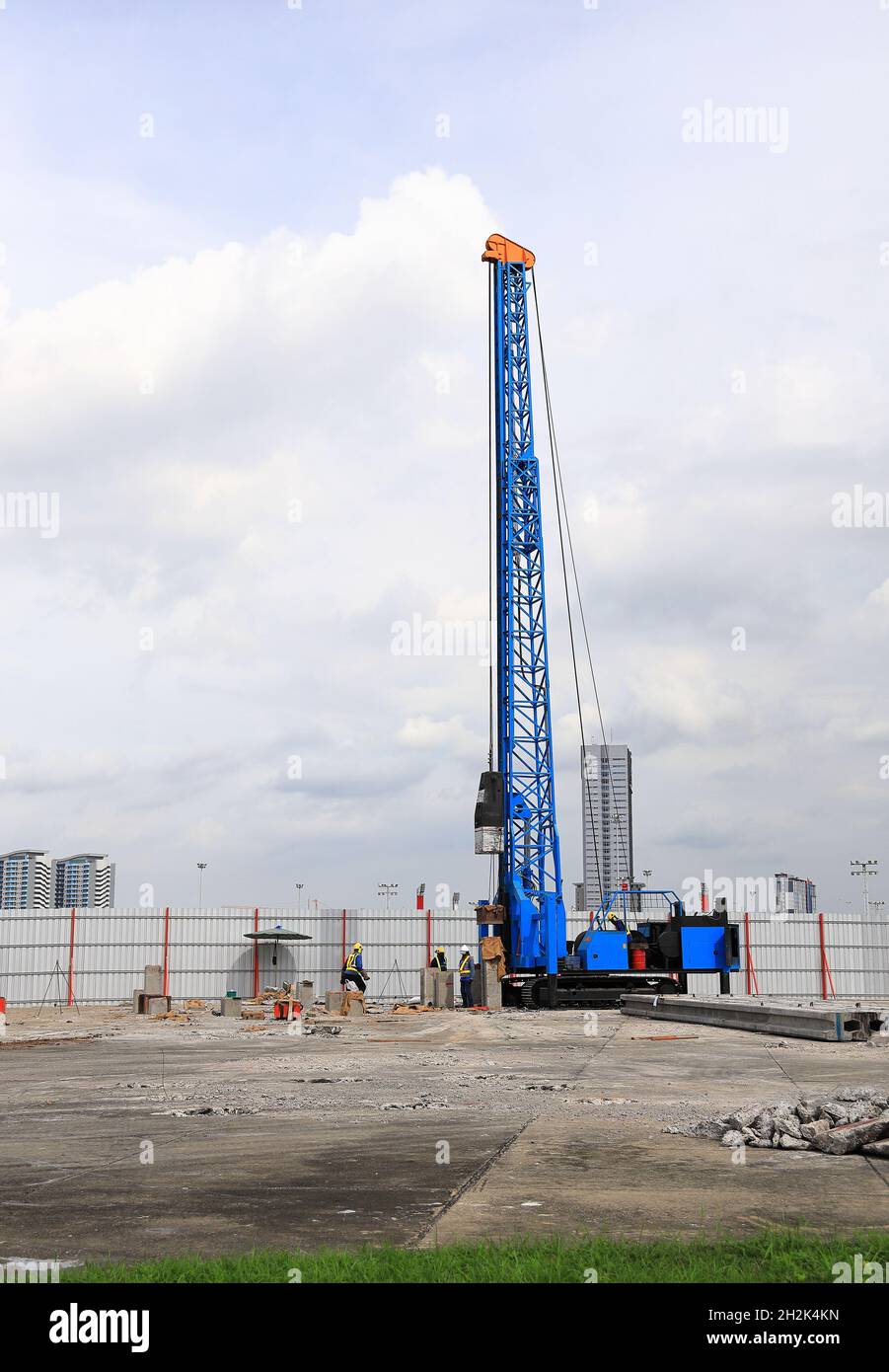 engineers and hammer pile driving machine working on construction area ...