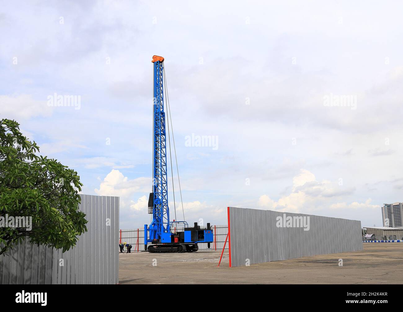 engineers and hammer pile driving machine working on construction area ...