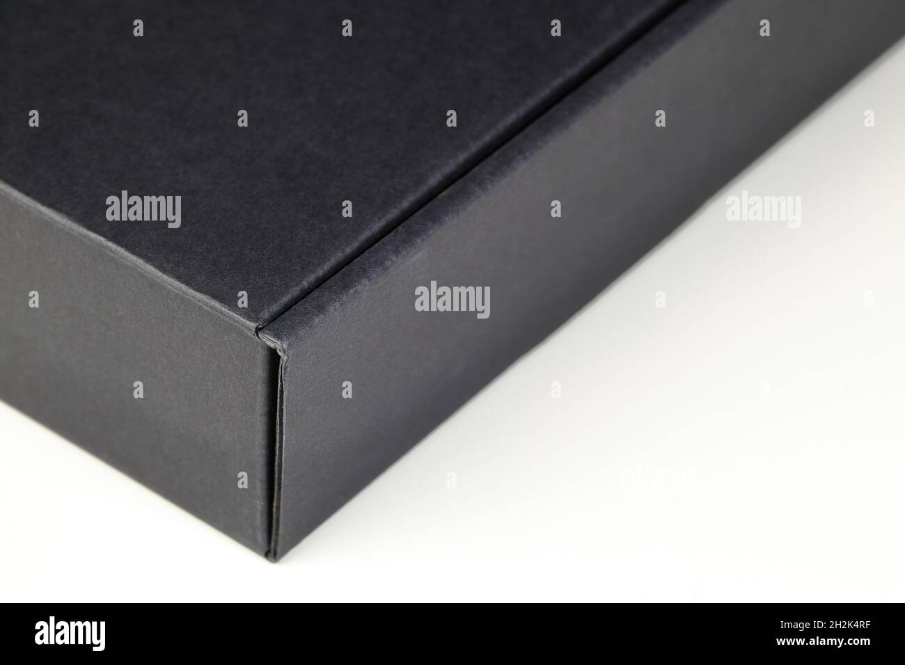 Right corner close up of Black Square Cardboard box for Parcel Delivery ...
