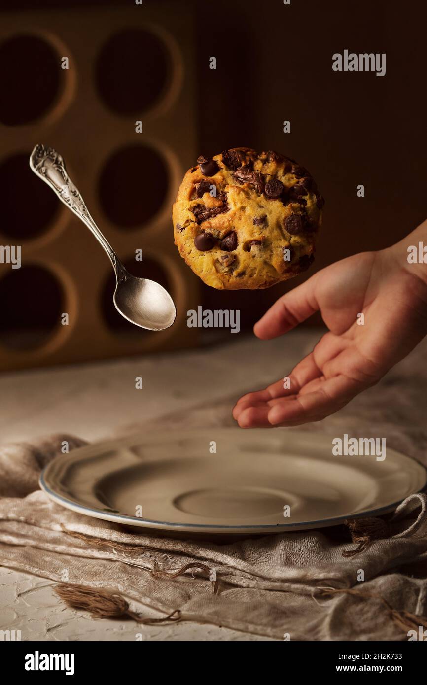 Male hand throwing a spoon and oatmeal with chocolate chips Stock Photo ...