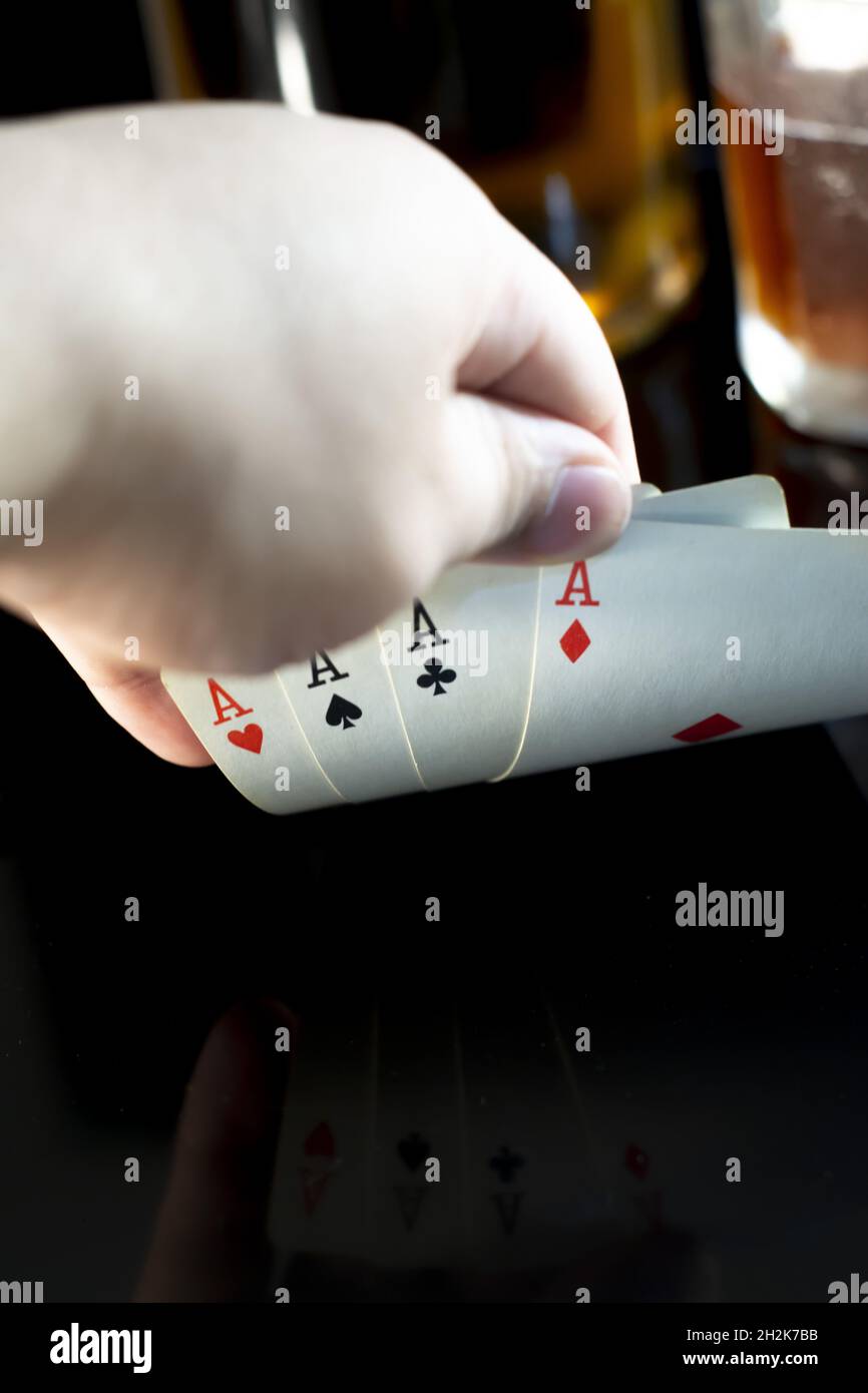 Hand holding four playing cards with aces Stock Photo - Alamy