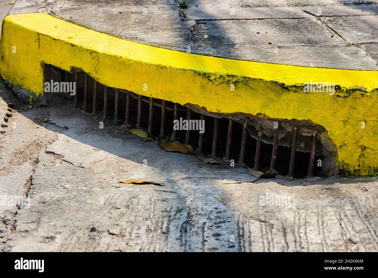 Gutter, street rain drain on a city road is blocked by a grid Stock ...