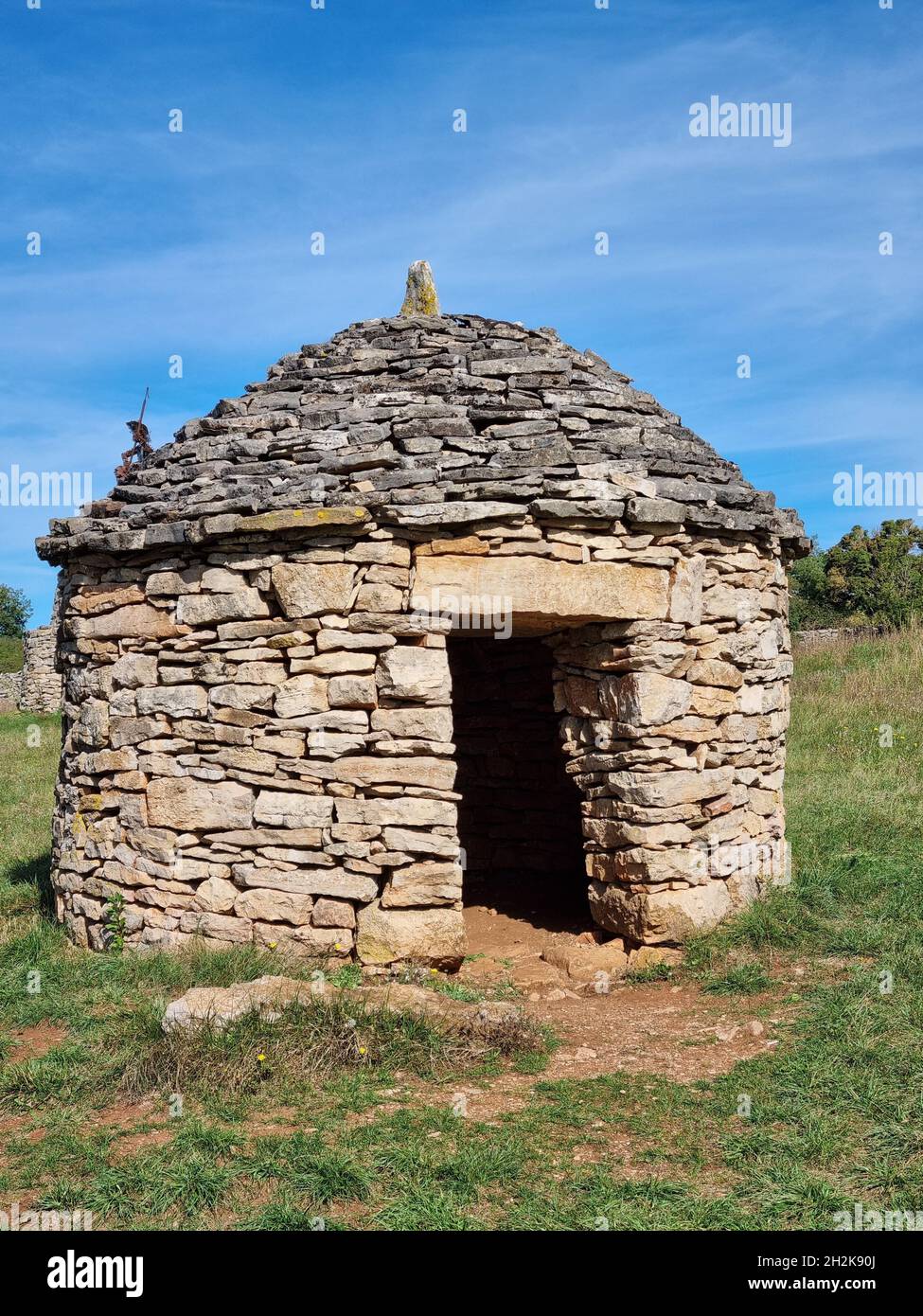 Vertical closeup of a small hut made of rocks in the field Stock Photo ...