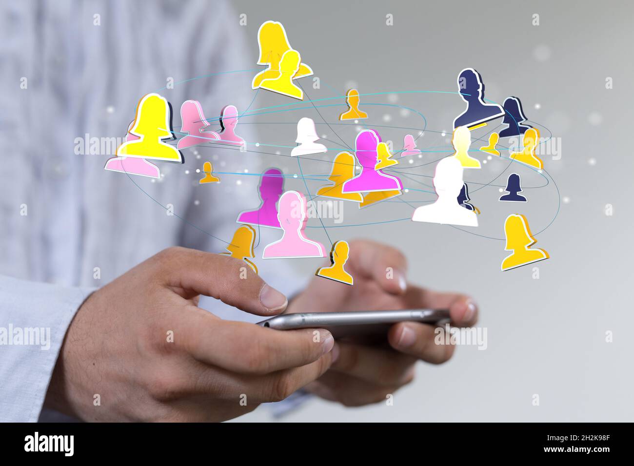 Male typing on his phone with floating profile icons - the concept of ...