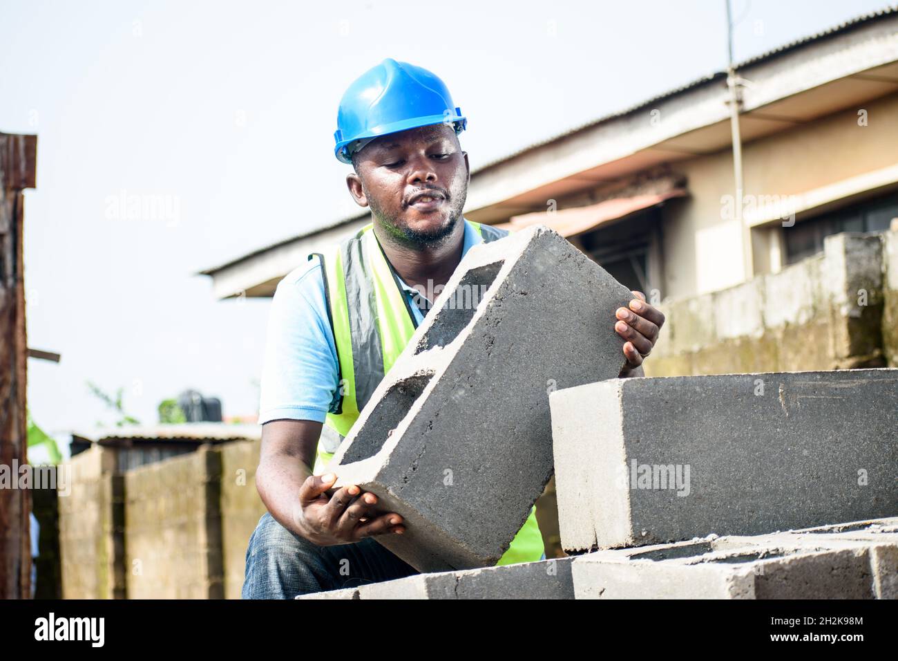 African construction worker wearing the reflective jacket while working ...