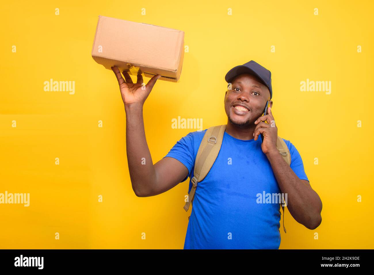 African dispatch man making a call Stock Photo - Alamy
