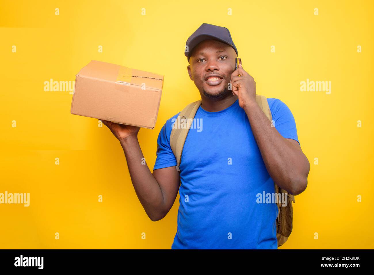 African dispatch man making a call Stock Photo - Alamy