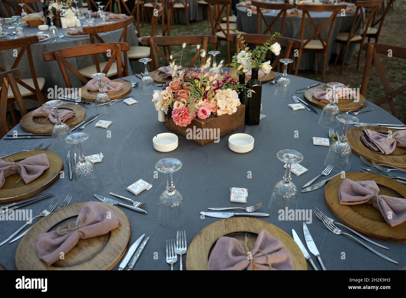 High-angle shot of a round table with wooden plates and other dishware ...