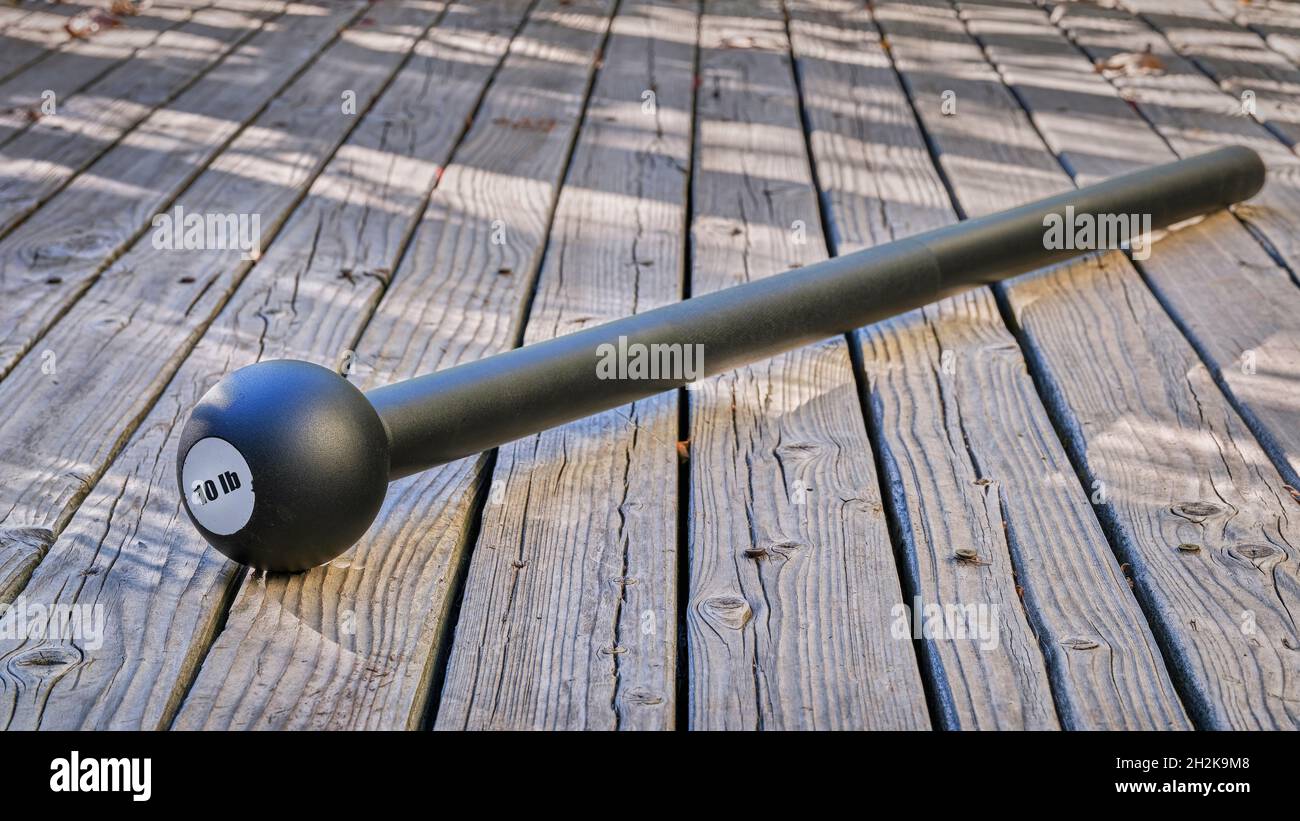 steel mace (or macebell) on a rustic wooden deck, functional fitness ...