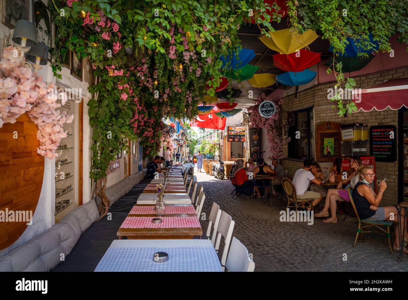Alacati, Izmir, Turkey - August 25 2021: Tables set up on the narrow ...