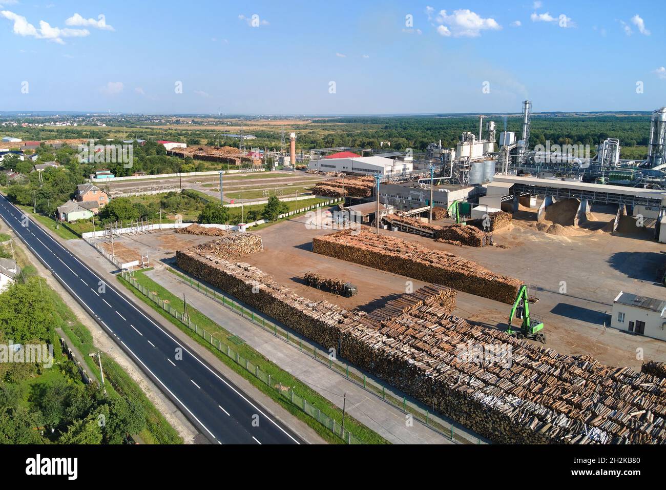 Aerial view of wood processing factory with stacks of lumber at plant ...