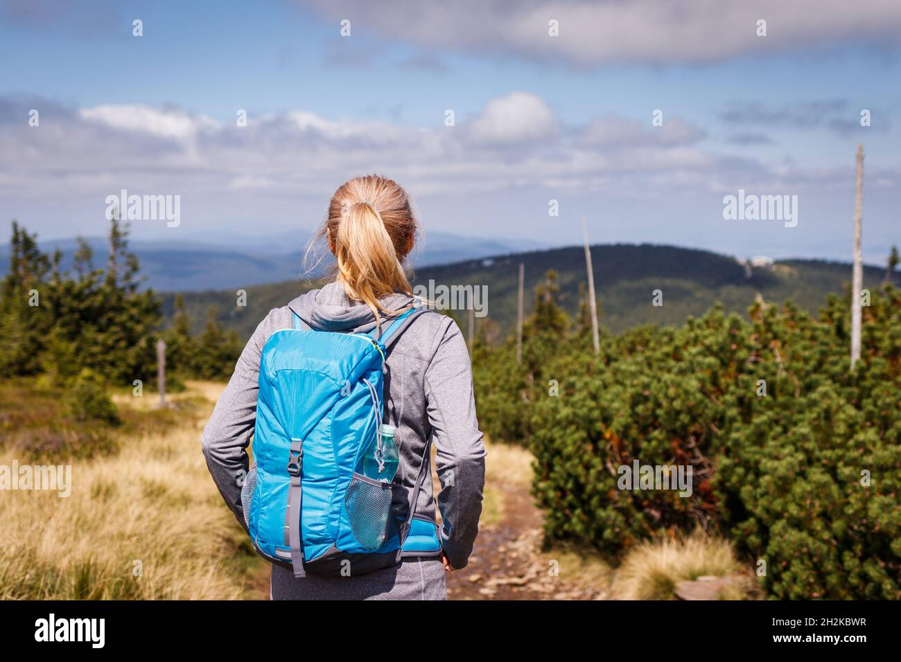 Woman with backpack hiking in mountains. Travel active lifestyle and ...