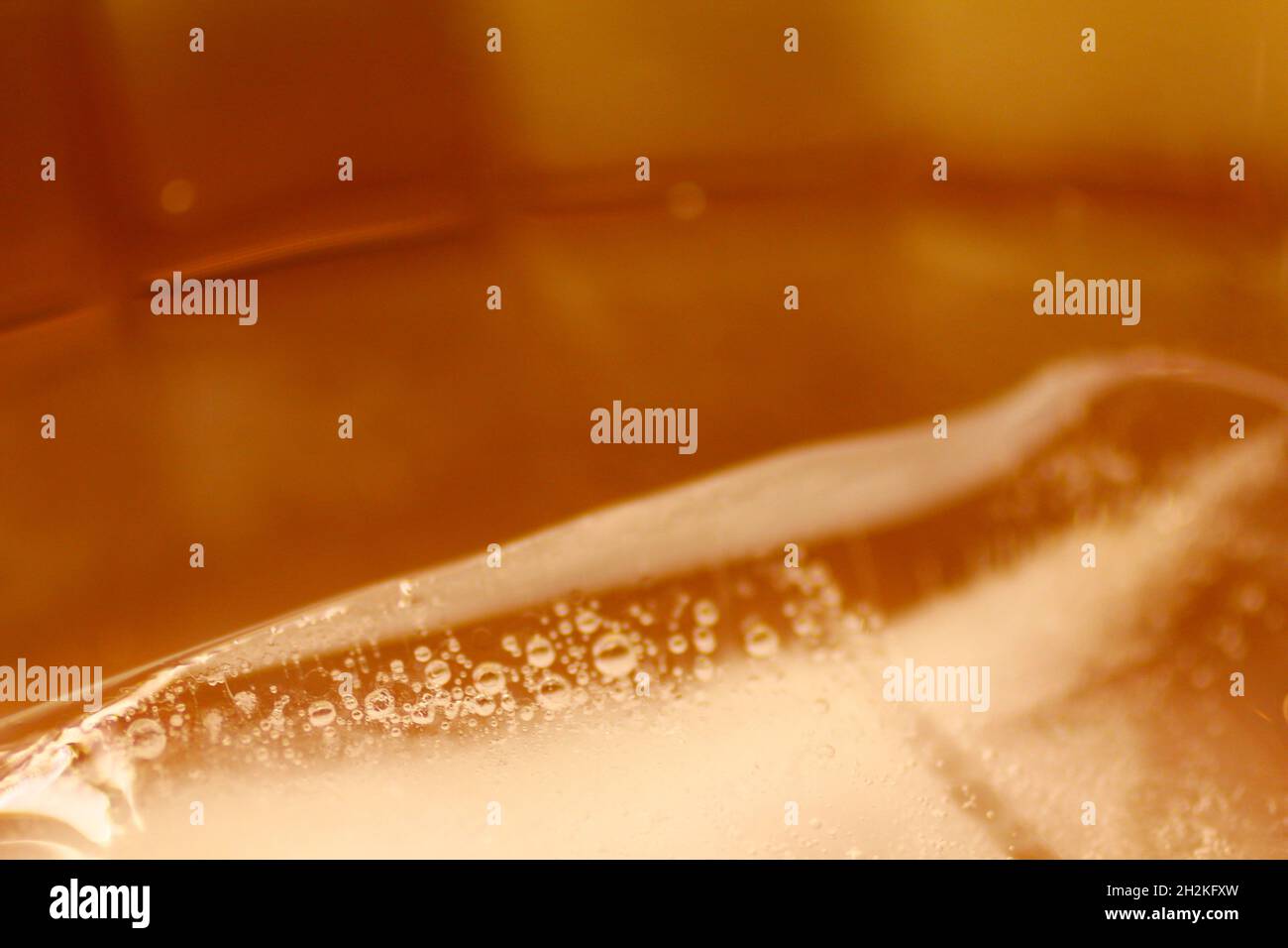 Glass of Ice Water Against a brown background Stock Photo - Alamy