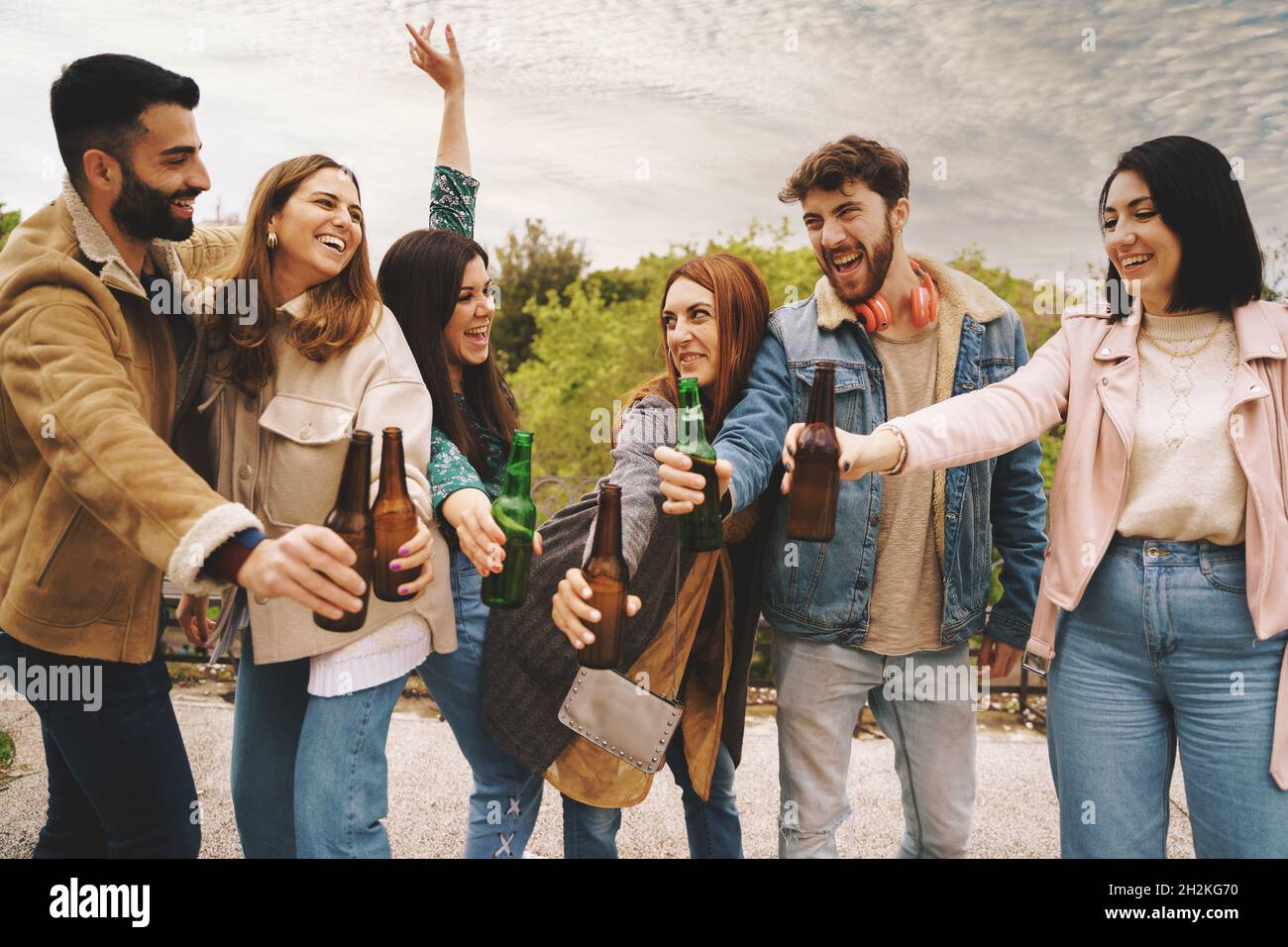 happy people dancing in the park and drinking beers together Stock ...