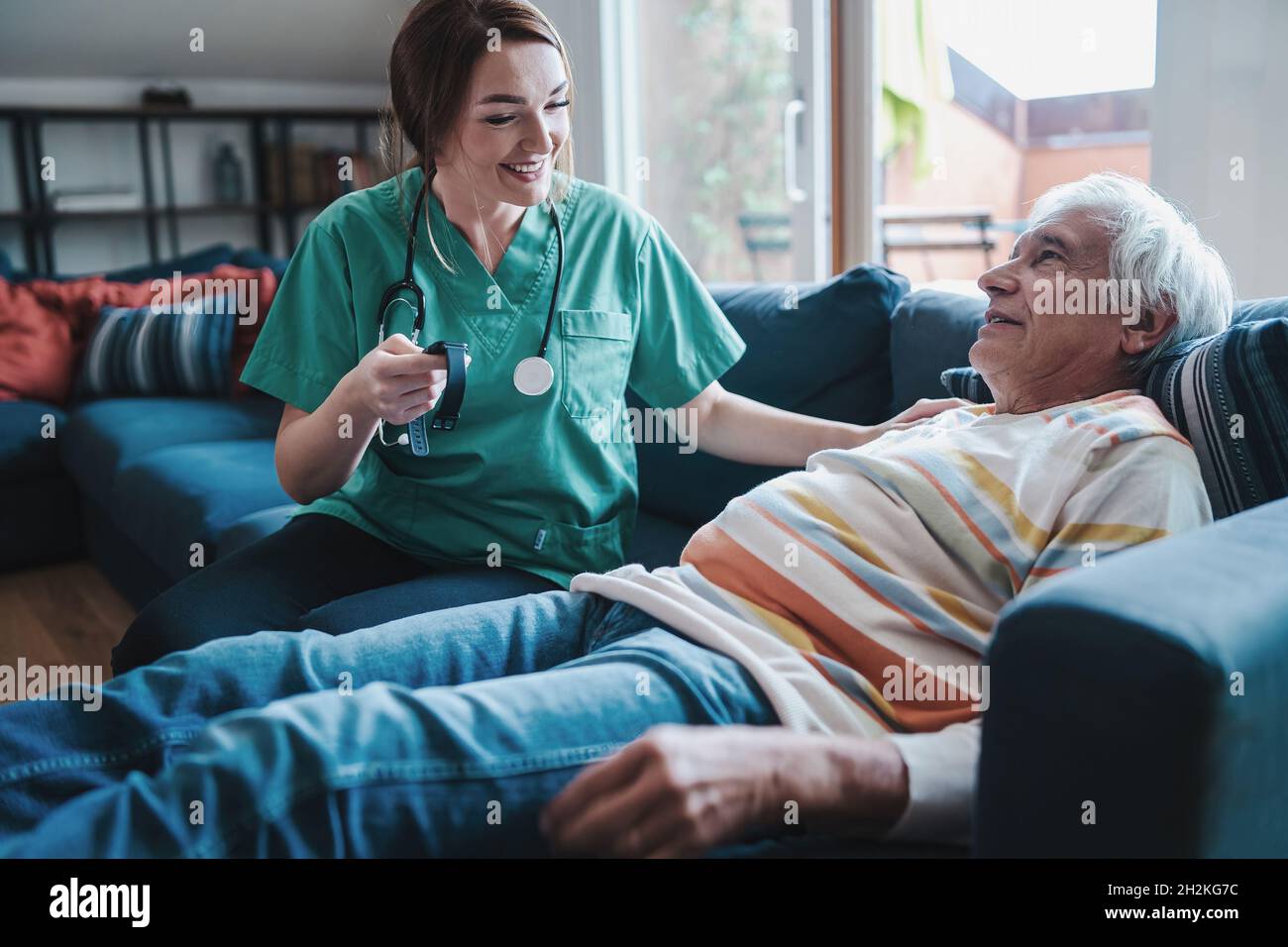 Smart wristband for assisted living - A woman of the healthcare staff ...