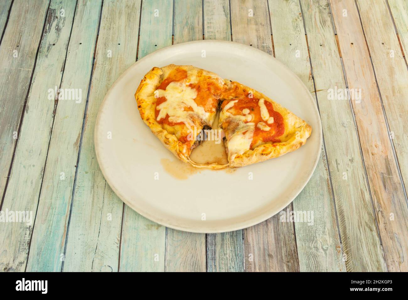 Top view image of Italian calzone with mozzarella cheese, tomato ...