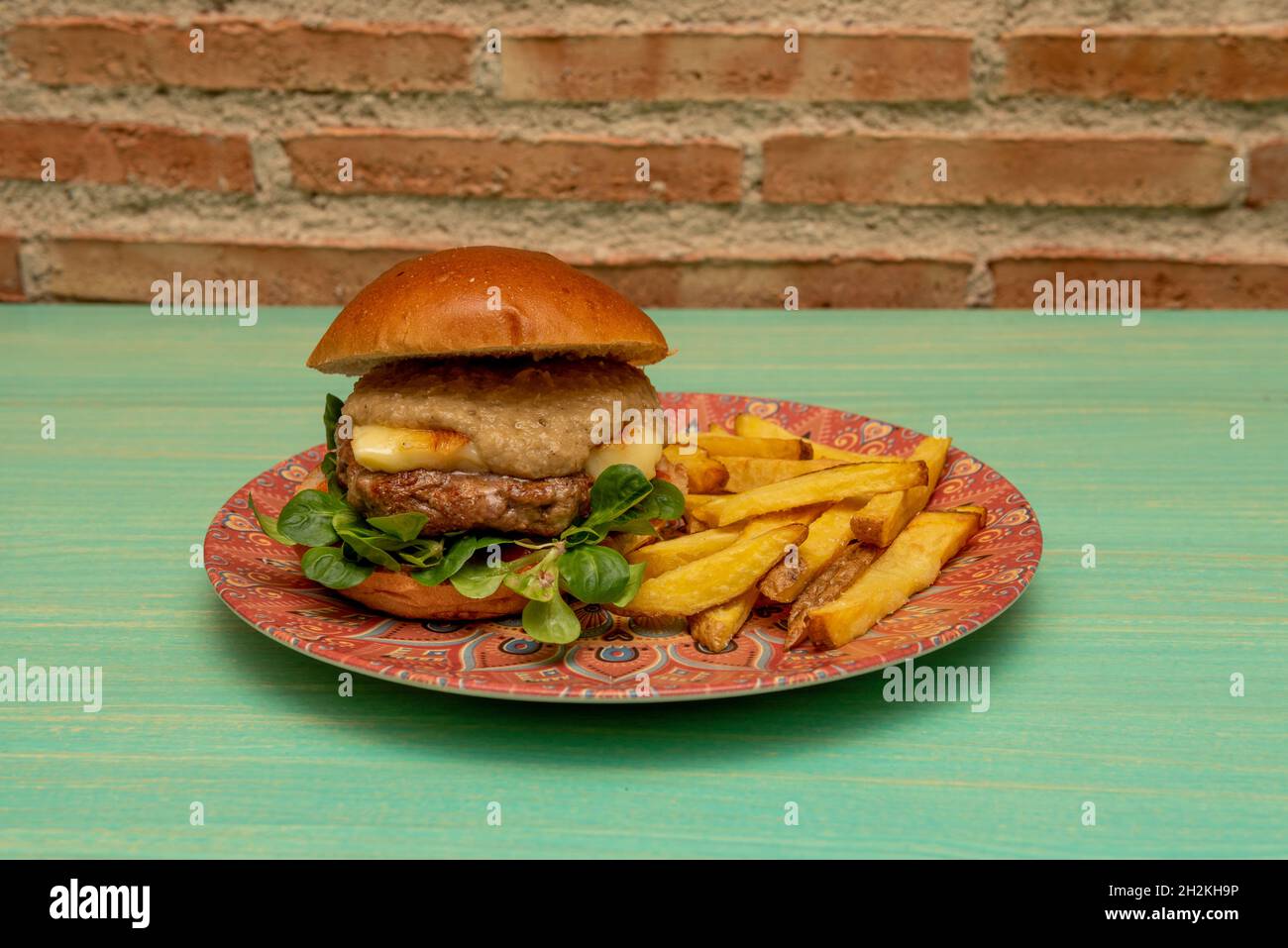Beef burger with brioche bread, melted Spanish Manchego cheese, cream ...