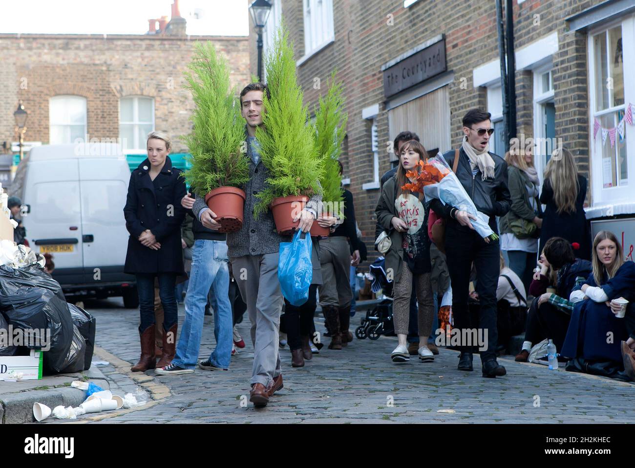 London, UK - 20 November 2019, A group of friends bought potted thuja ...